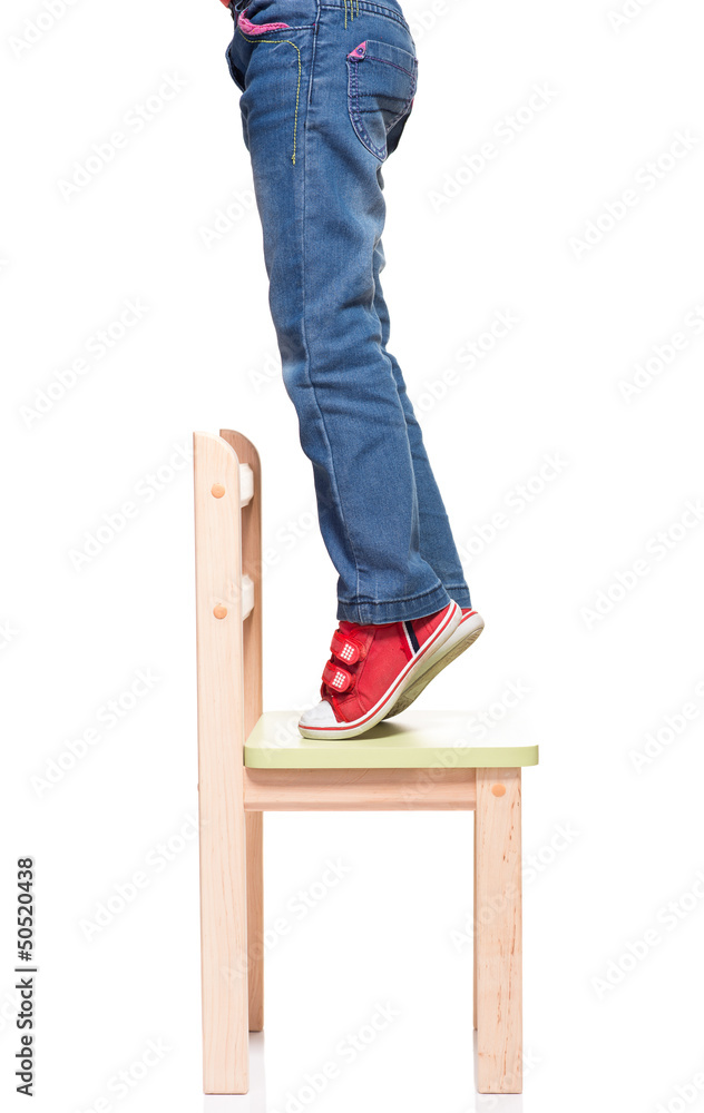 child's feet standing on the little chair on tiptoes Stock Photo ...