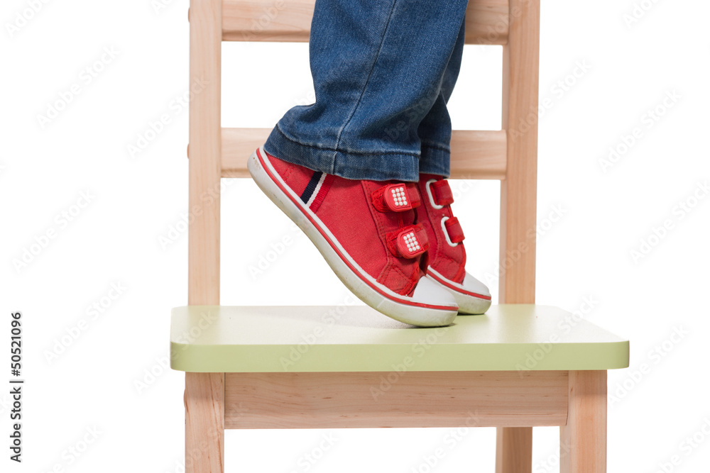child's feet standing on the little chair on tiptoes Stock Photo ...