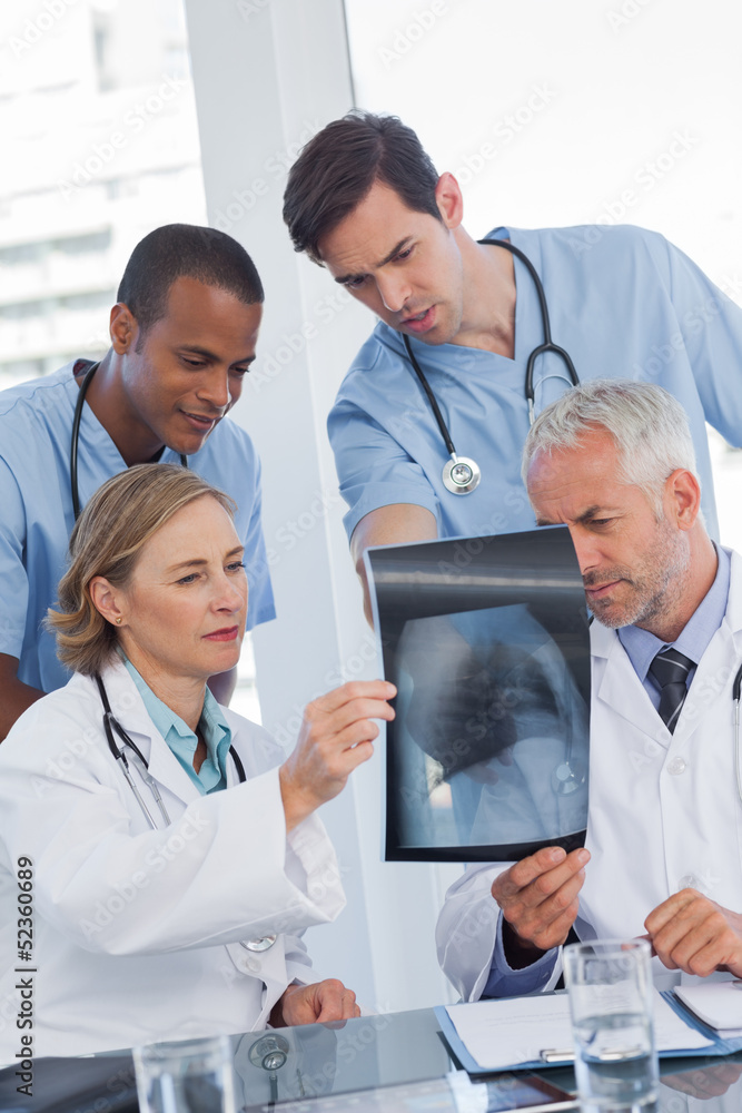 Serious medical team examining radiography Stock Photo | Adobe Stock