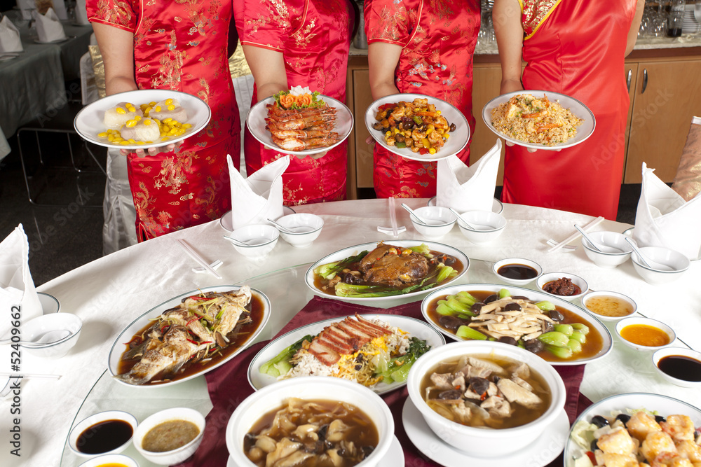 Chinese food, full rounded table of Chinese food with waitress Stock ...