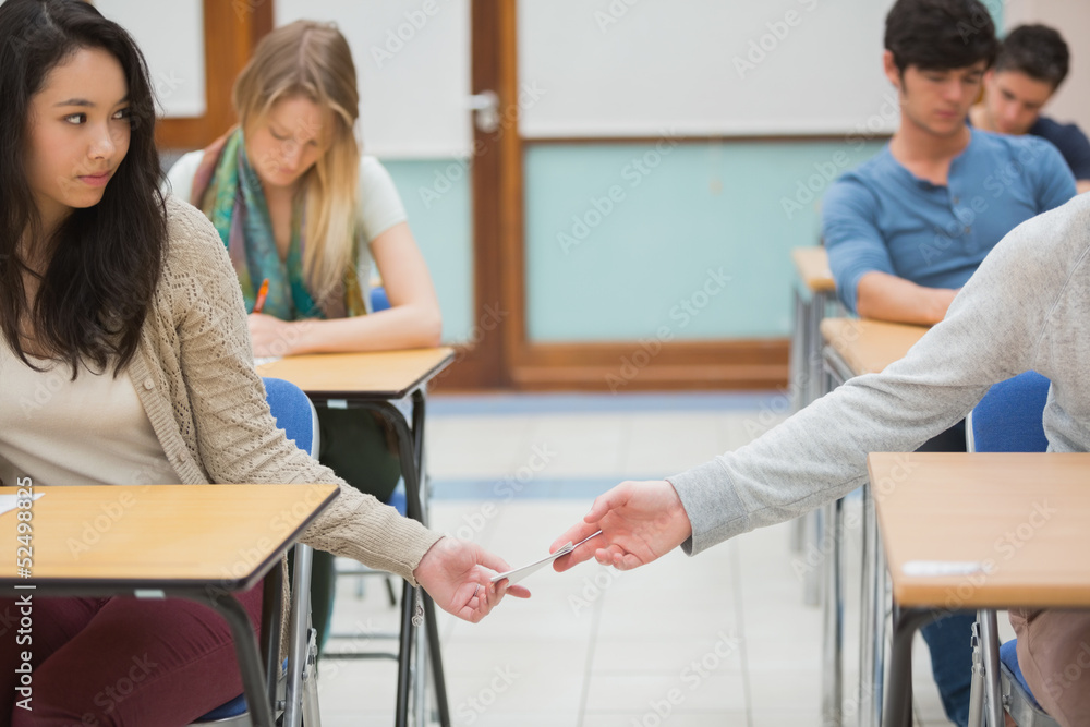 Two students cheating in the classroom Stock Photo | Adobe Stock