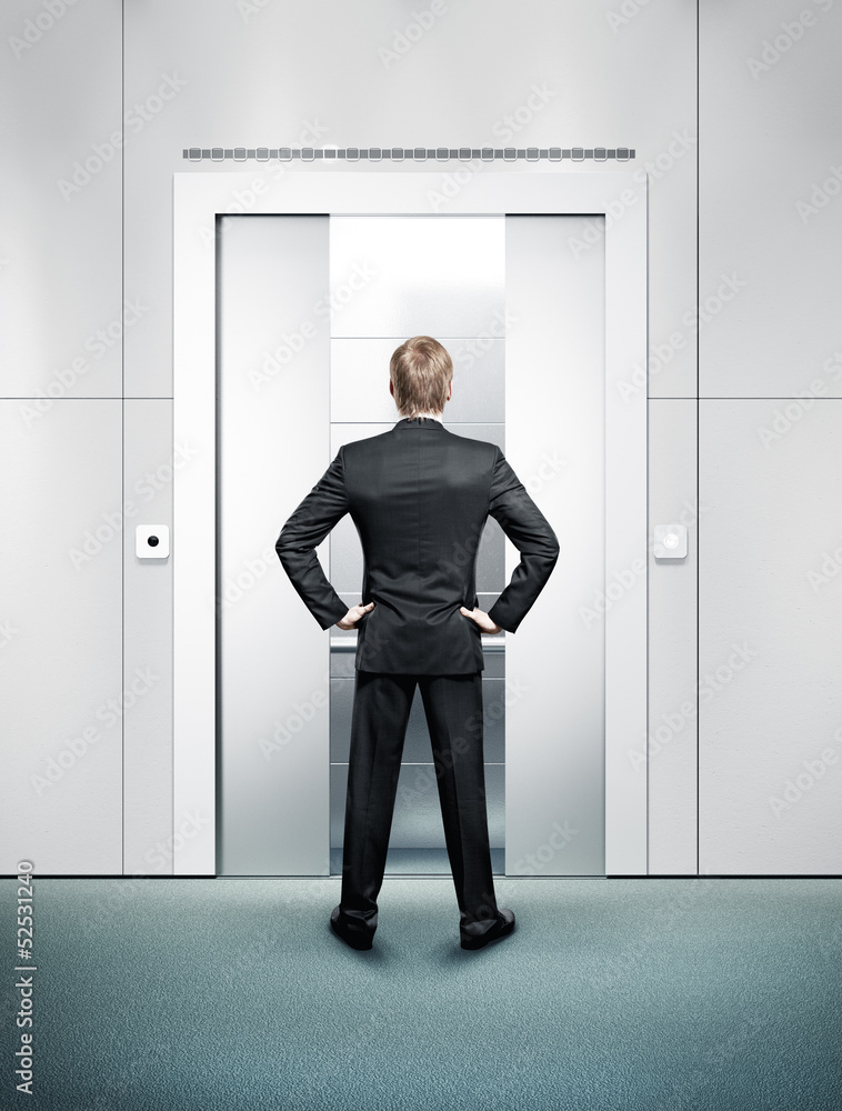 man standing in front of elevator's door Stock Photo | Adobe Stock