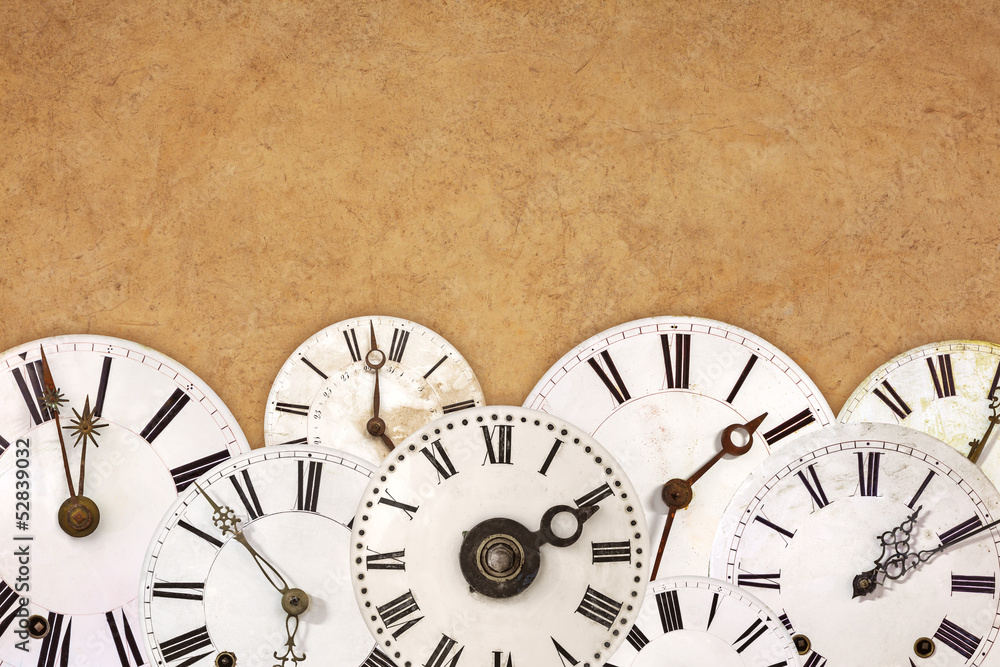 Set of vintage white clock faces against an old brown background Stock ...