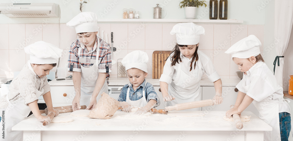 happy little chefs preparing dough in the kitchen with their Stock-Foto ...