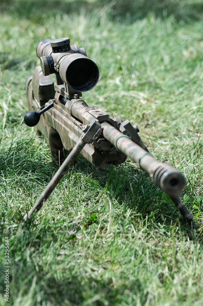 Sniper rifle with riflescope in grass Stock Photo | Adobe Stock