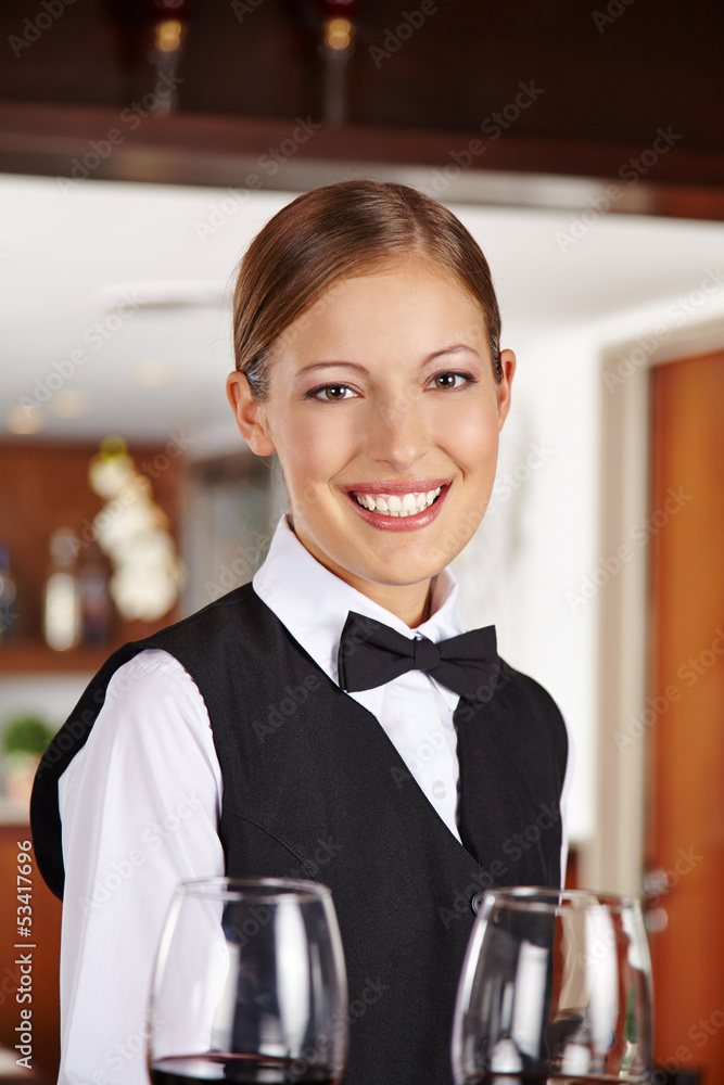 Kellnerin mit Weingläsern im Hotel Stock Photo | Adobe Stock