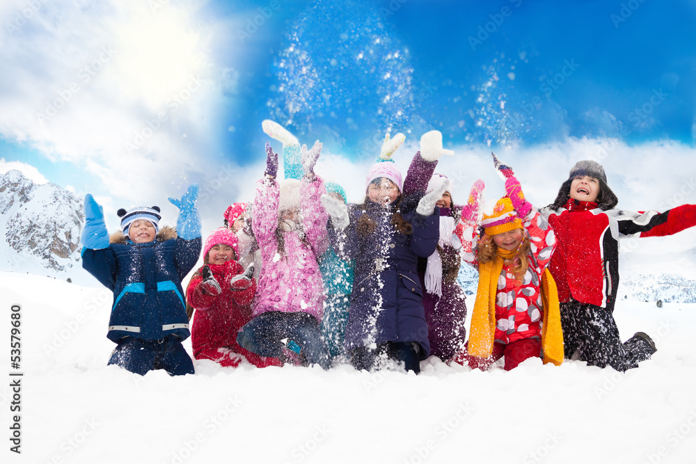 Group of happy kids throwing snow Stock Photo | Adobe Stock