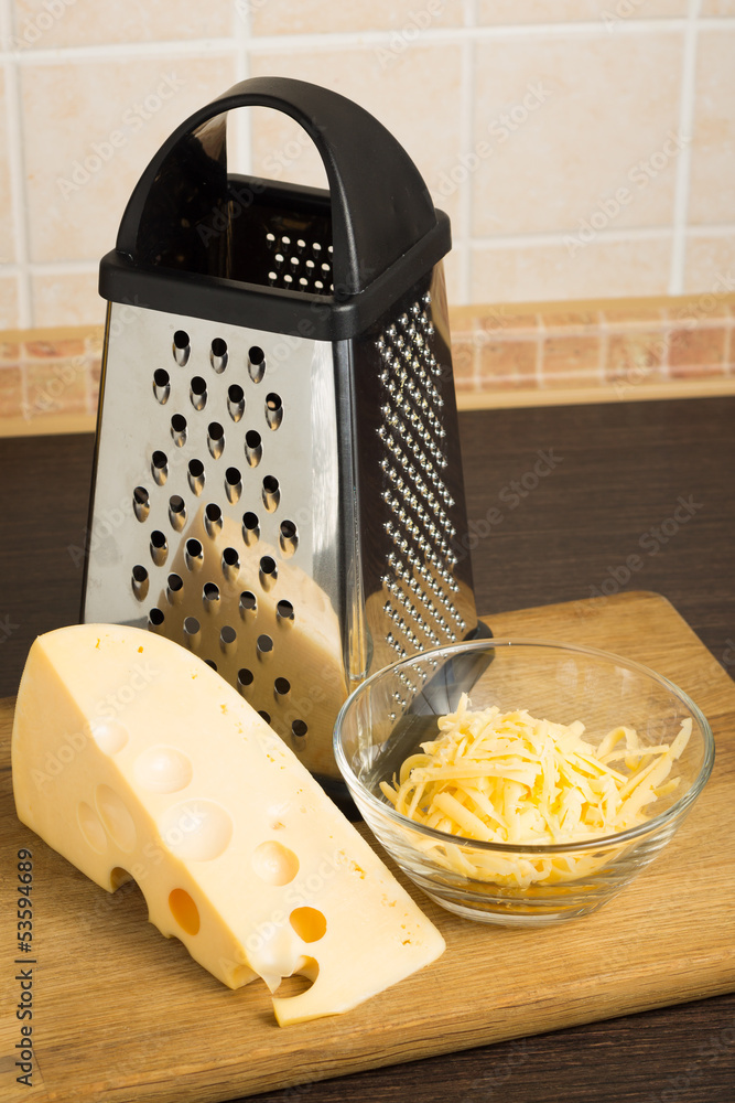 Grated Yellow Cheese with Grater at the kitchen Stock Photo | Adobe Stock
