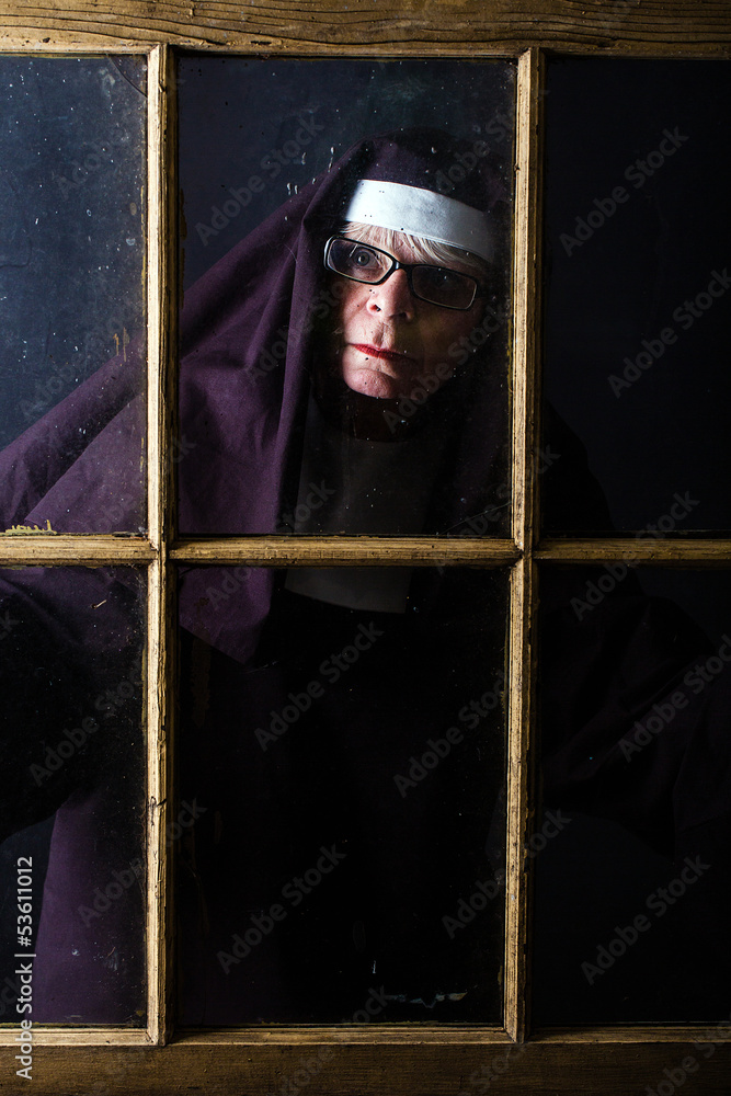 nun looking out a window Stock Photo | Adobe Stock