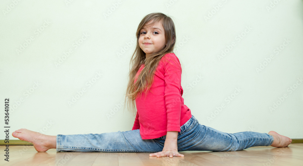 Little girl sits on a splits Stock Photo | Adobe Stock