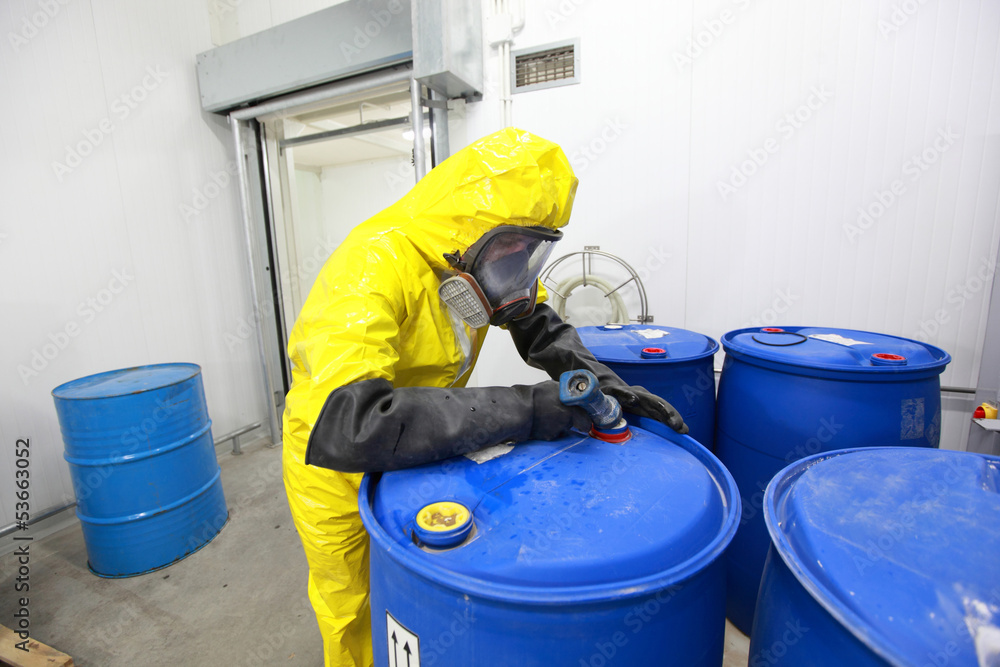 Professional in uniform filling barrels with chemicals Stock-Foto ...