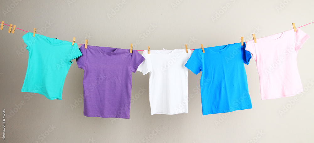 Laundry line with clothes on wall background Stock Photo | Adobe Stock