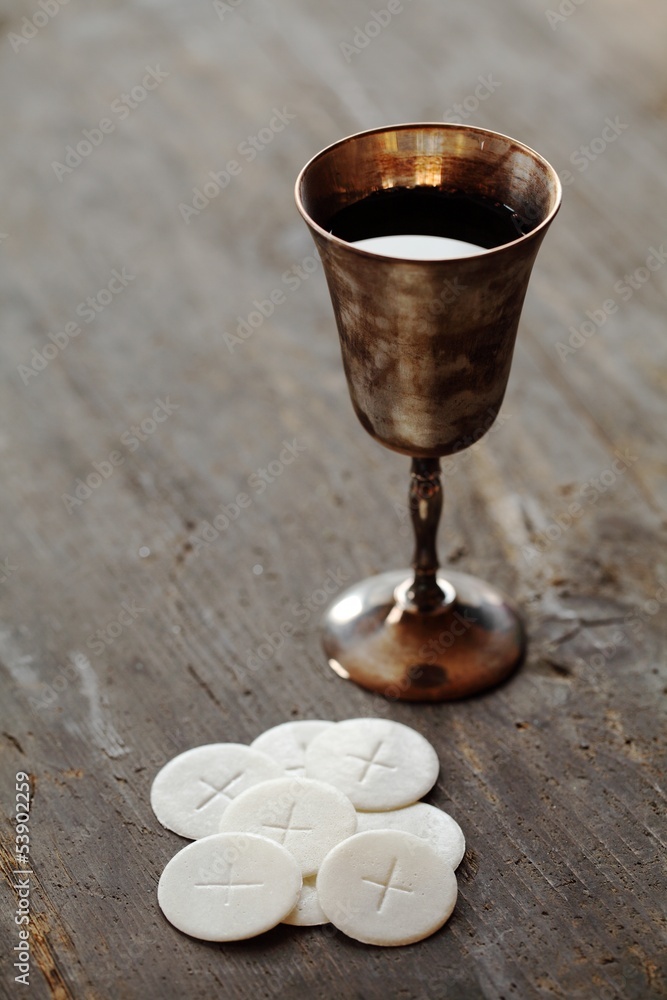Chalice with wine and communion wafers on wooden background Stock Photo ...