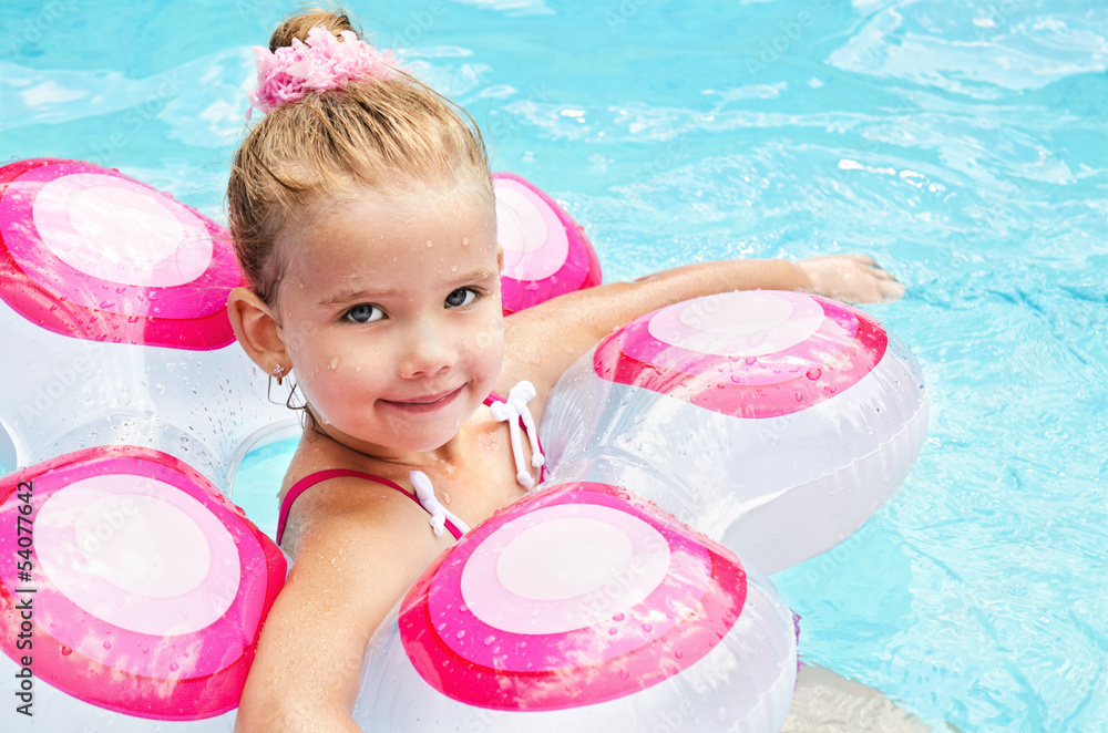 Pretty little girl in swimming pool Stock Photo | Adobe Stock
