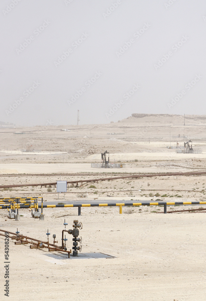 Broad view of oil wellhead and Oil pumps in Bahrain oil field Stock ...