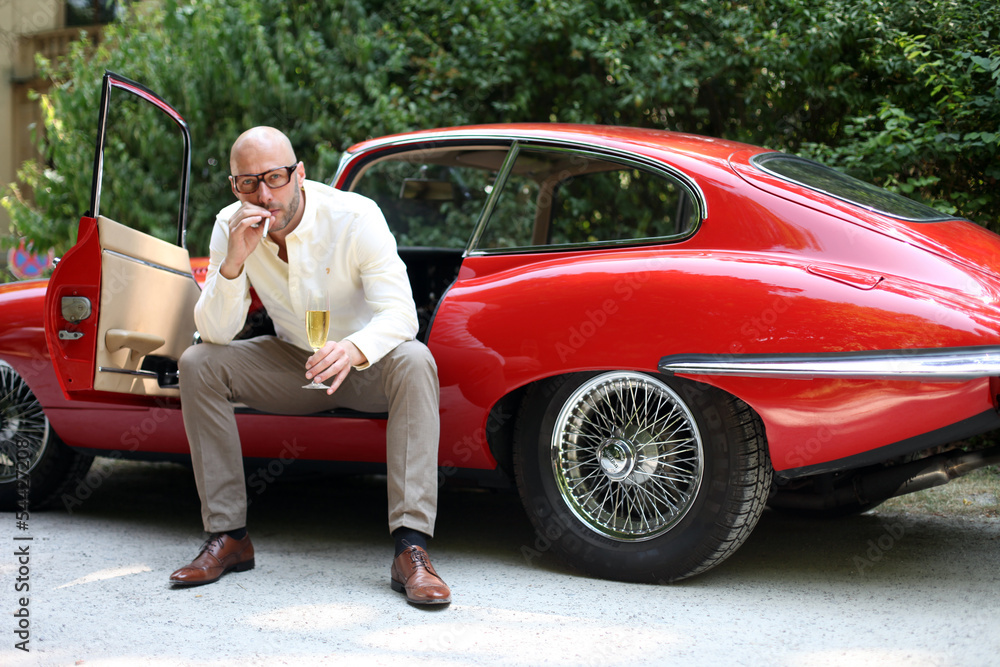 Mann sitzt im Oldtimer Stock Photo | Adobe Stock