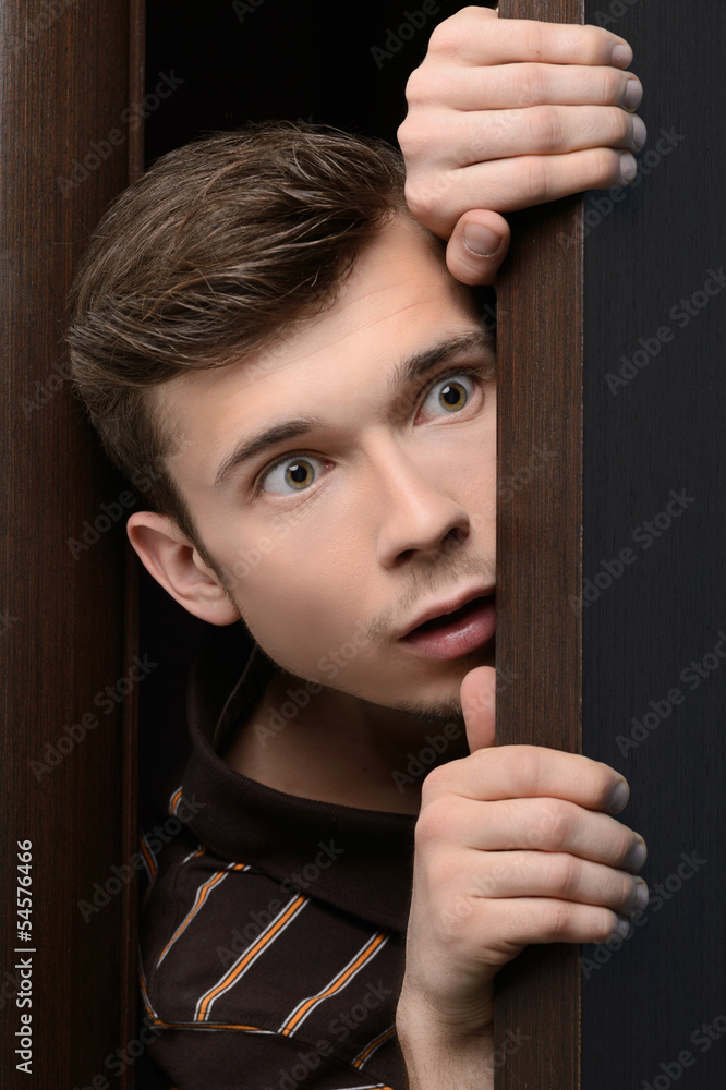 Men peeking. Close-up of surprised young men peeking through the Stock ...