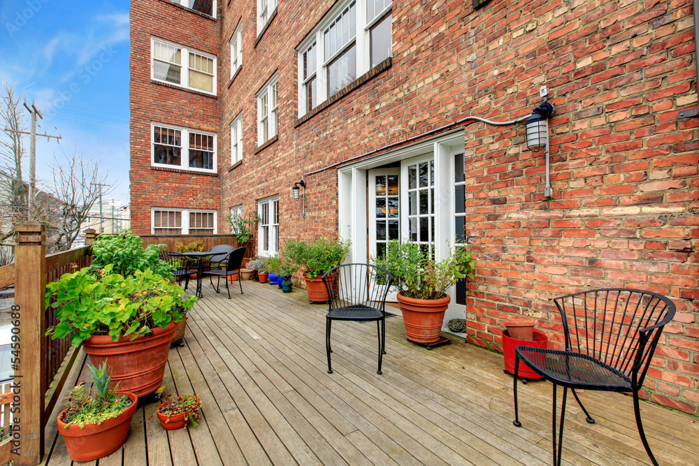 Brick apartment building large outdoor terrace. Stock Photo | Adobe Stock