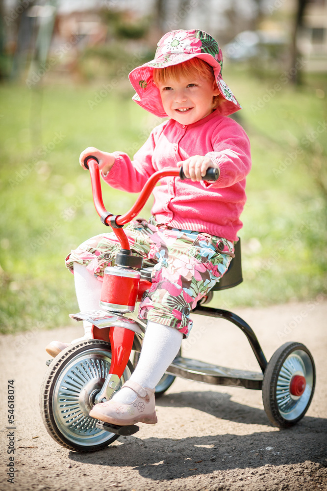 little girl on tricycle Stock Photo | Adobe Stock