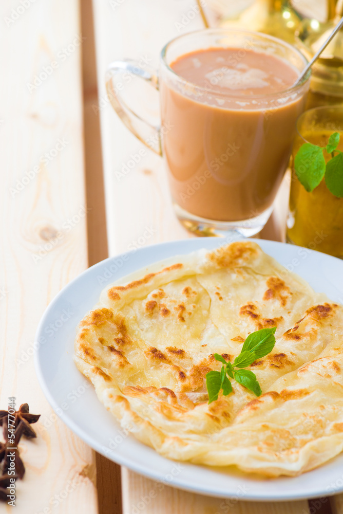 roti canai and teh tarik, very famous drink and food in malaysia Stock ...