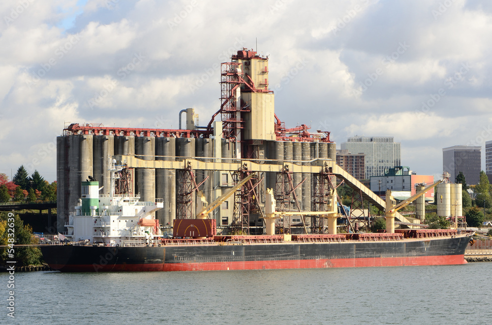 Large grain ship next to a silo loading facility Stock Photo | Adobe Stock