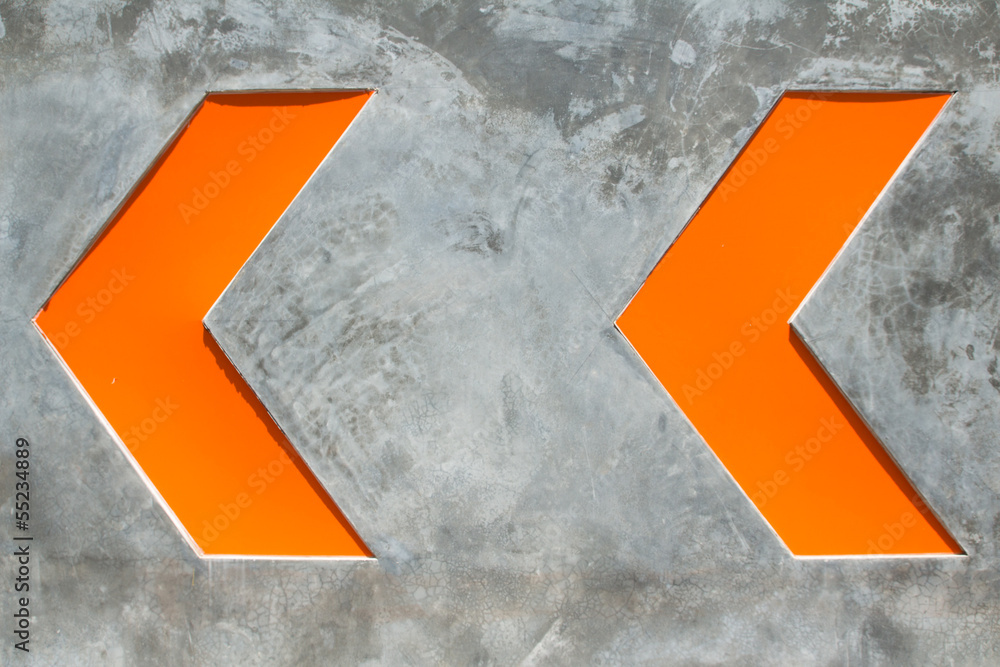 Orange arrow sign on cement background Stock Photo | Adobe Stock