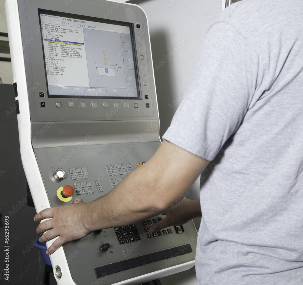 Operator using control panel of a CNC lathe machine Stock Photo | Adobe ...