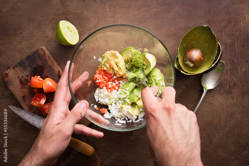 Mashing vegetables to make guacamole Stock Photo | Adobe Stock