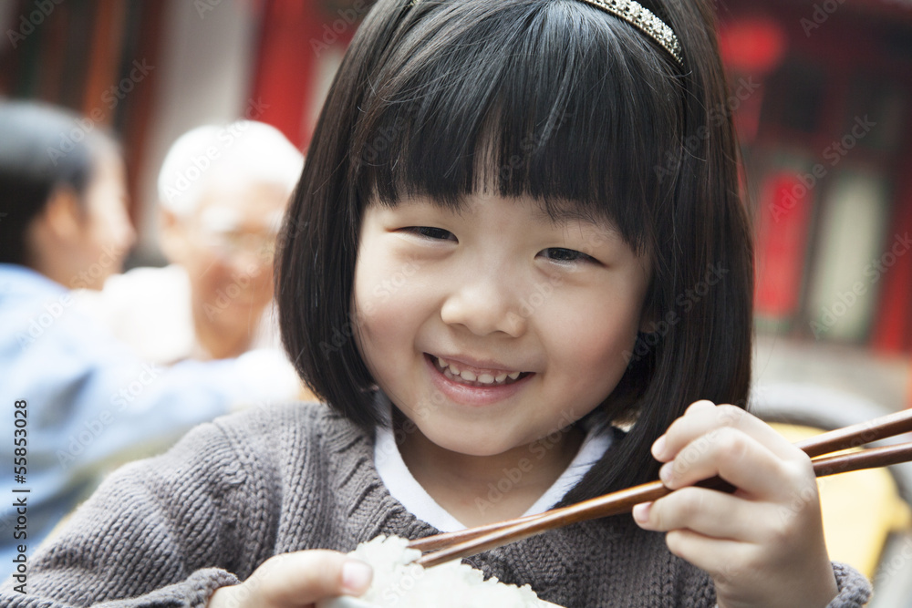 Portrait of little girl eating rice Stock Photo | Adobe Stock