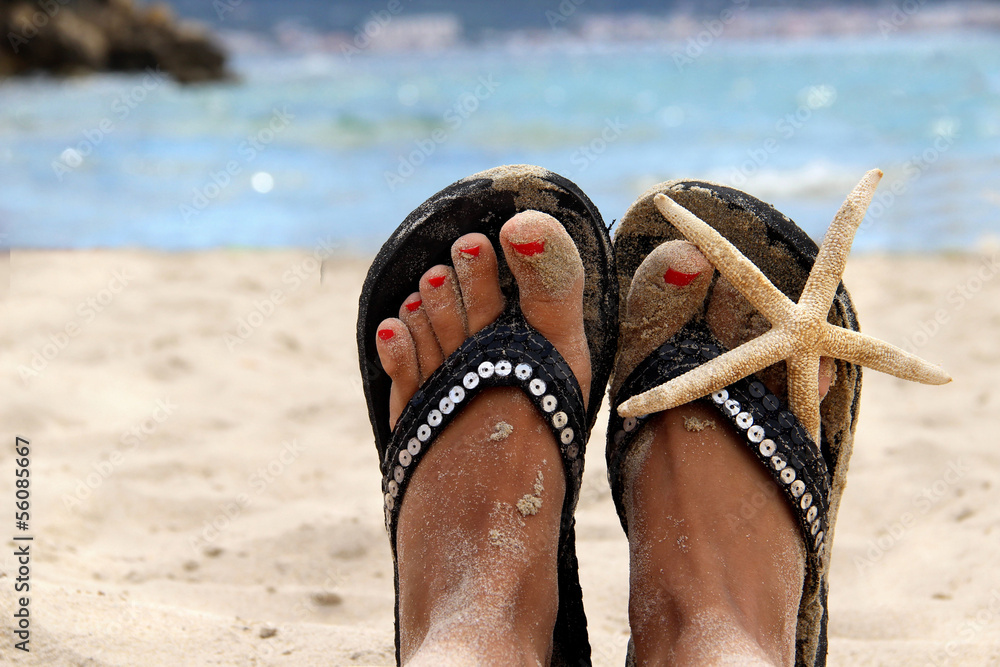 Beautiful female feet on the beach and starfish Stock Photo | Adobe Stock