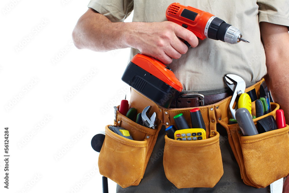Handyman with a tool belt and drill. Stock Photo | Adobe Stock