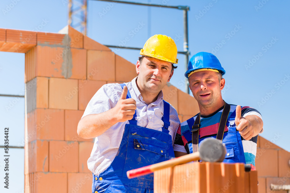 Construction site workers building walls on house Stock Photo | Adobe Stock