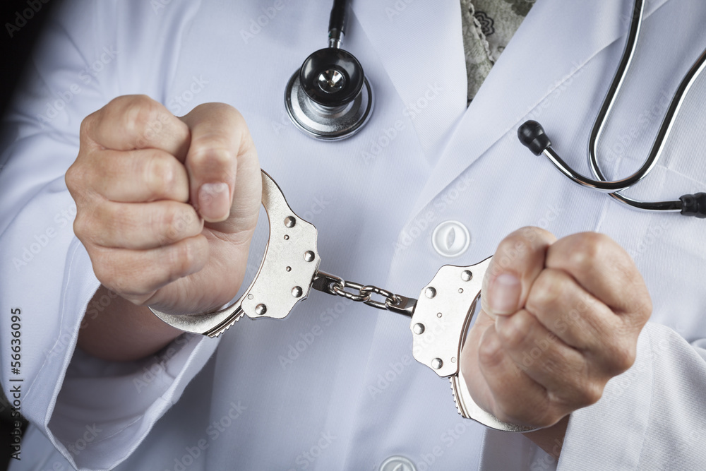 Doctor or Nurse In Handcuffs Wearing Lab Coat and Stethoscope Stock ...