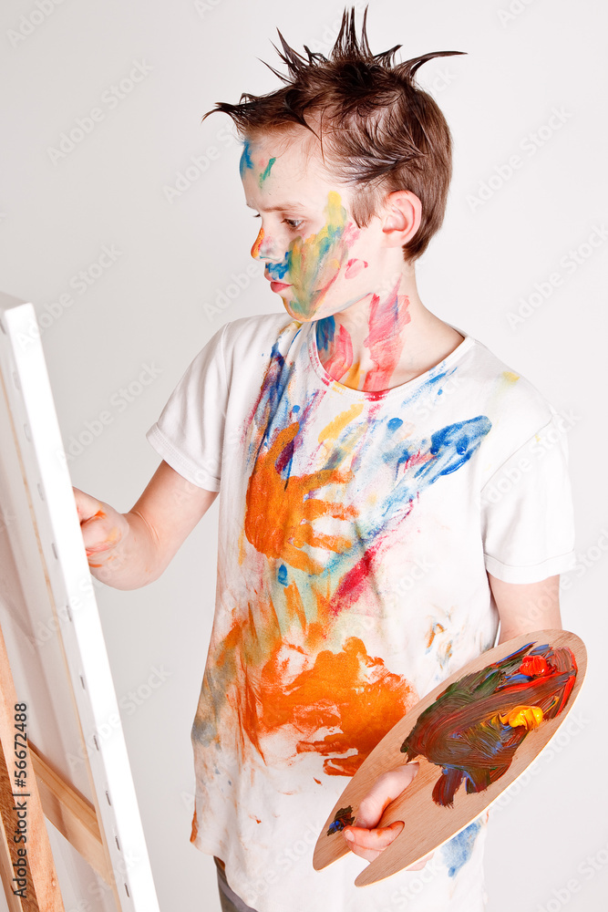 Boy painting on a canvas Stock Photo | Adobe Stock
