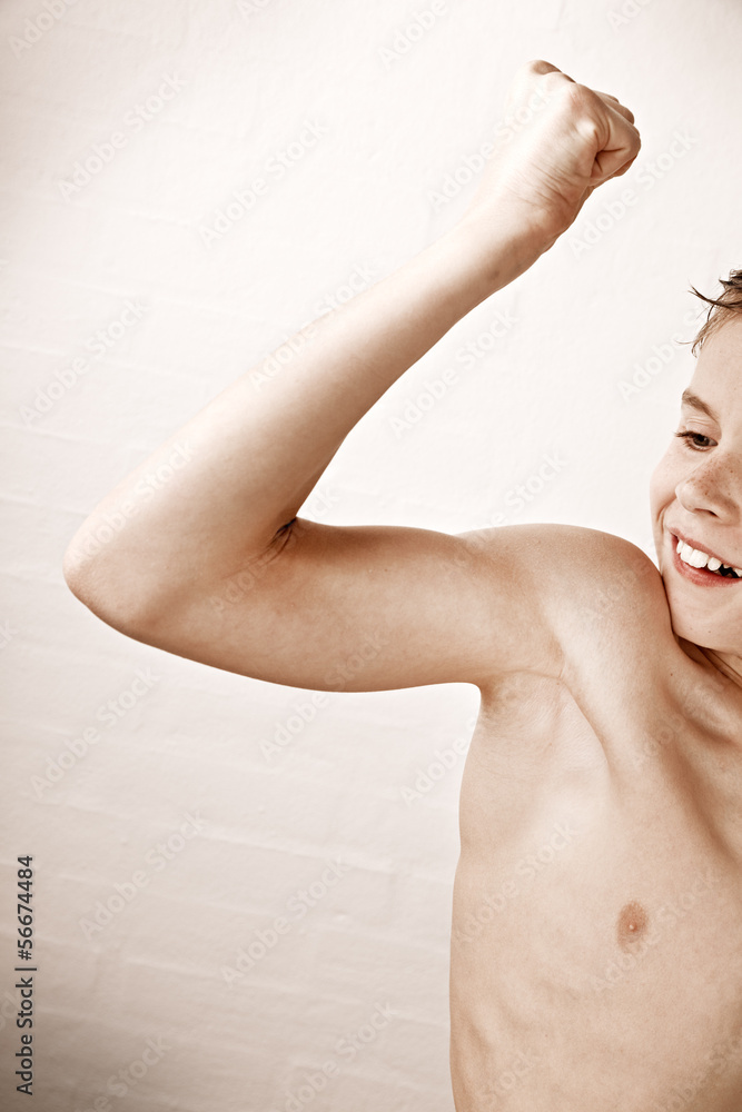 Side profile of a boy flexing bicep Stock Photo | Adobe Stock
