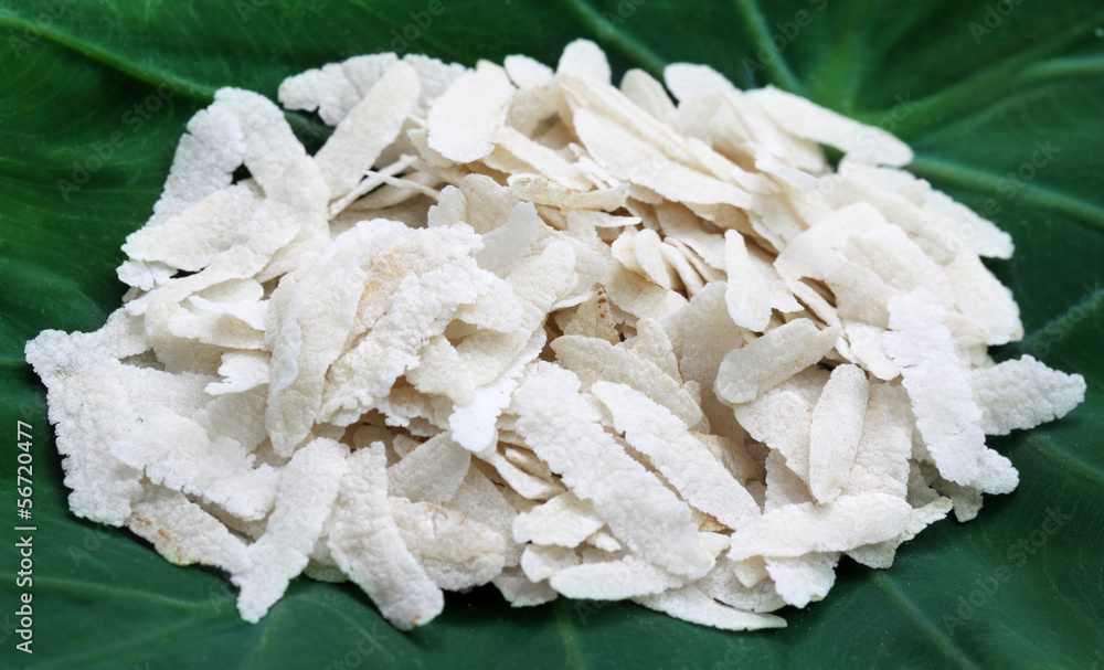 Flattened rice of South East Asia on green leaf Stock Photo | Adobe Stock