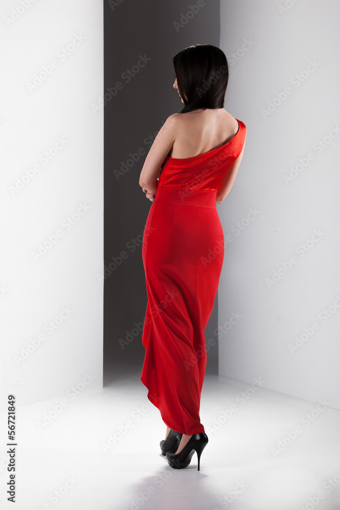 Sexy girl posing from back in evening red dress Stock Photo | Adobe Stock