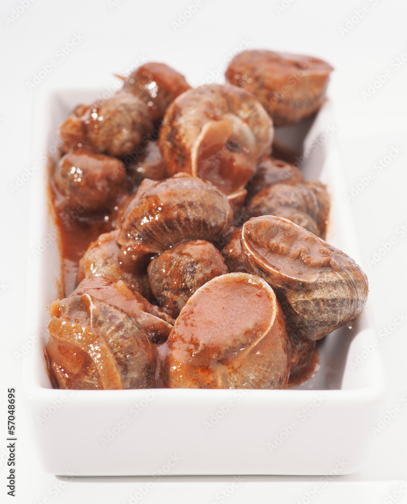 escargot cooked in sauce served in porcelain tray Stock Photo | Adobe Stock