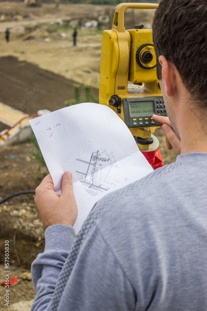 Photo & Art Print Land surveyor analyzing a cadastral and site plans on ...