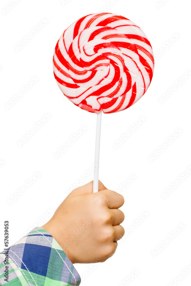 Hand holding big red lollipop. Stock Photo | Adobe Stock