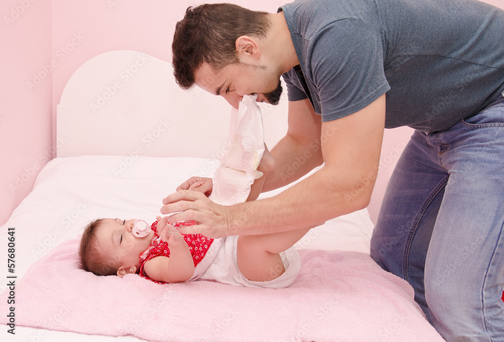 Dad changing baby diapers Stock Photo | Adobe Stock