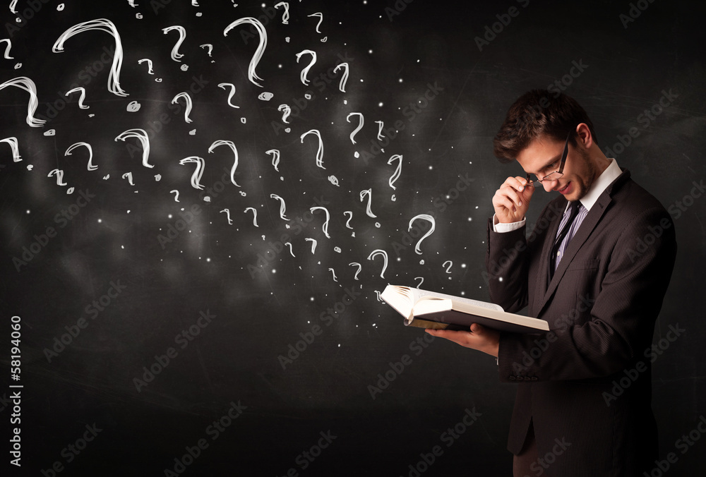 Young man reading a book with question marks coming out from it Stock ...