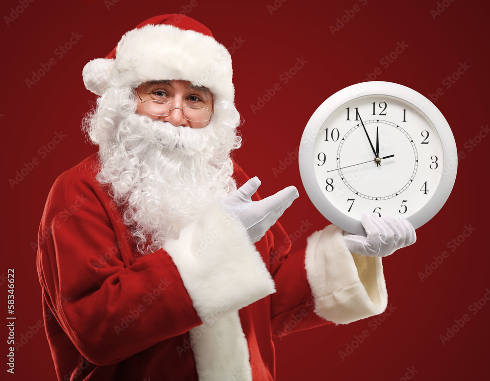 Santa pointing at clock showing five minutes to midnight Stock Photo ...