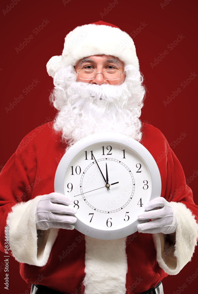 Santa pointing at clock showing five minutes to midnight Stock Photo ...