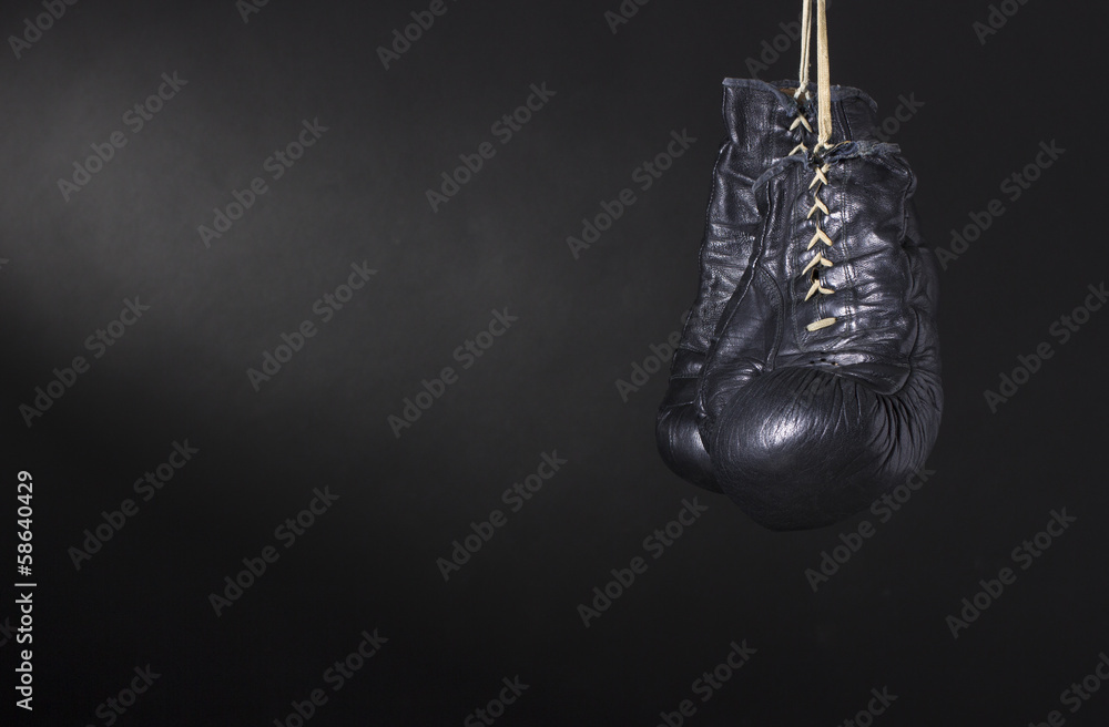 Boxing gloves on a dark background. Stock Photo | Adobe Stock