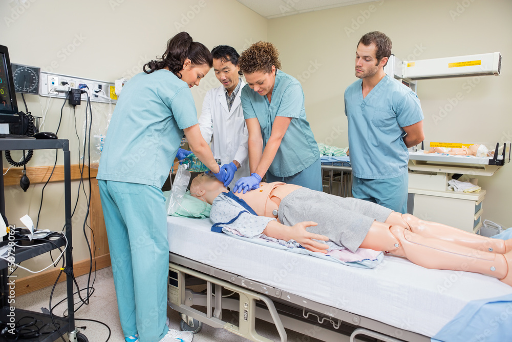 Nurse Performing CPR On Dummy Patient Stock Photo | Adobe Stock