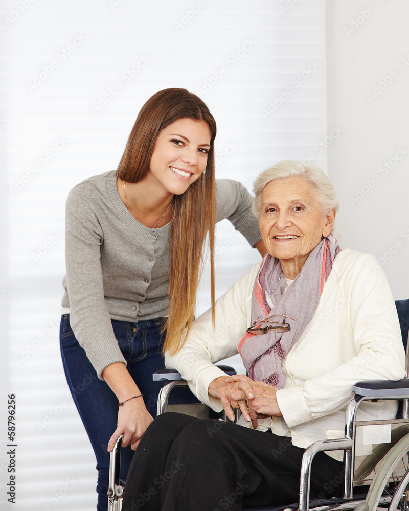 Young woman and senior citizen in wheelchair Stock Photo | Adobe Stock