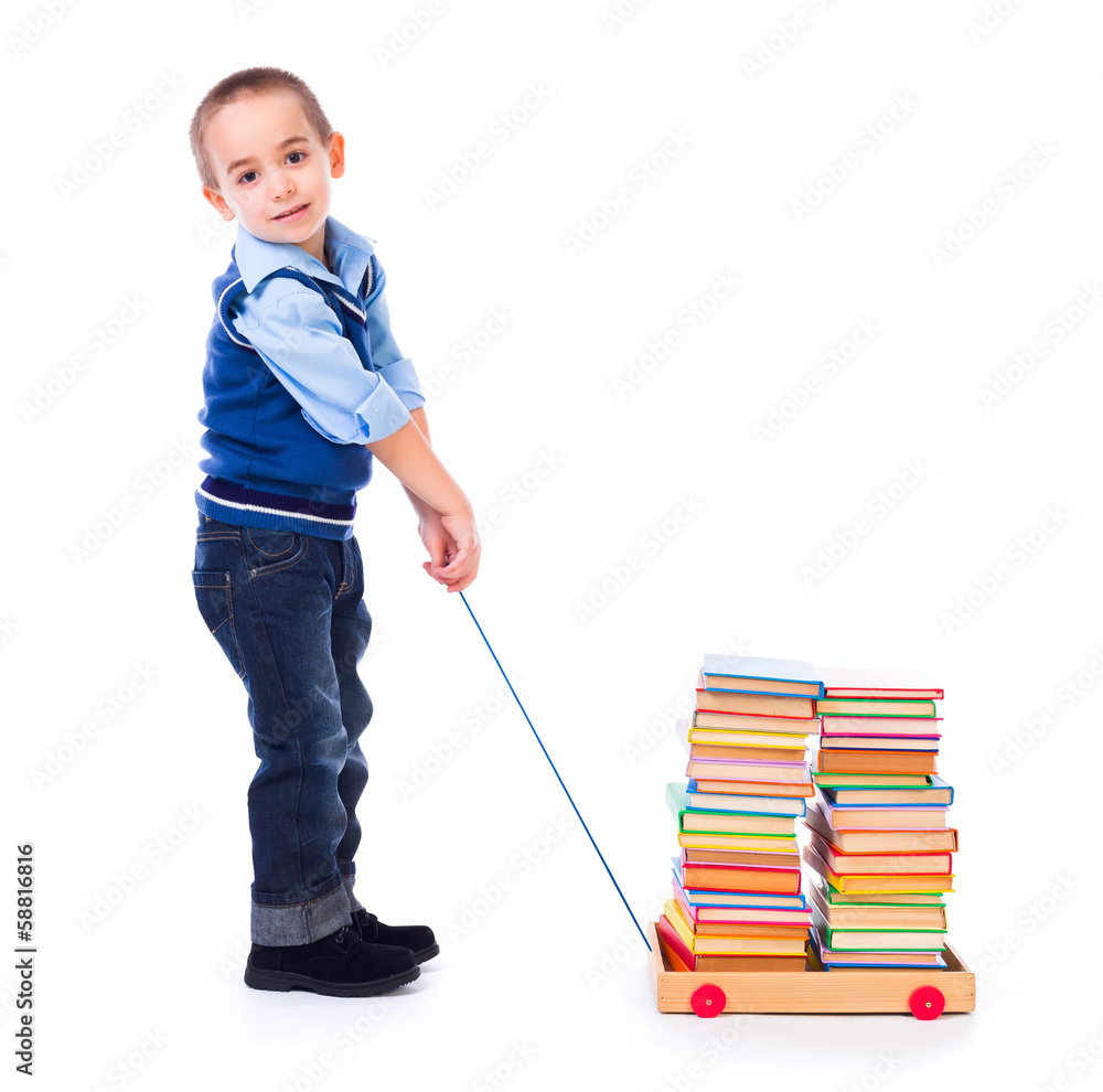 Little boy pulling books in toy cart Stock Photo | Adobe Stock
