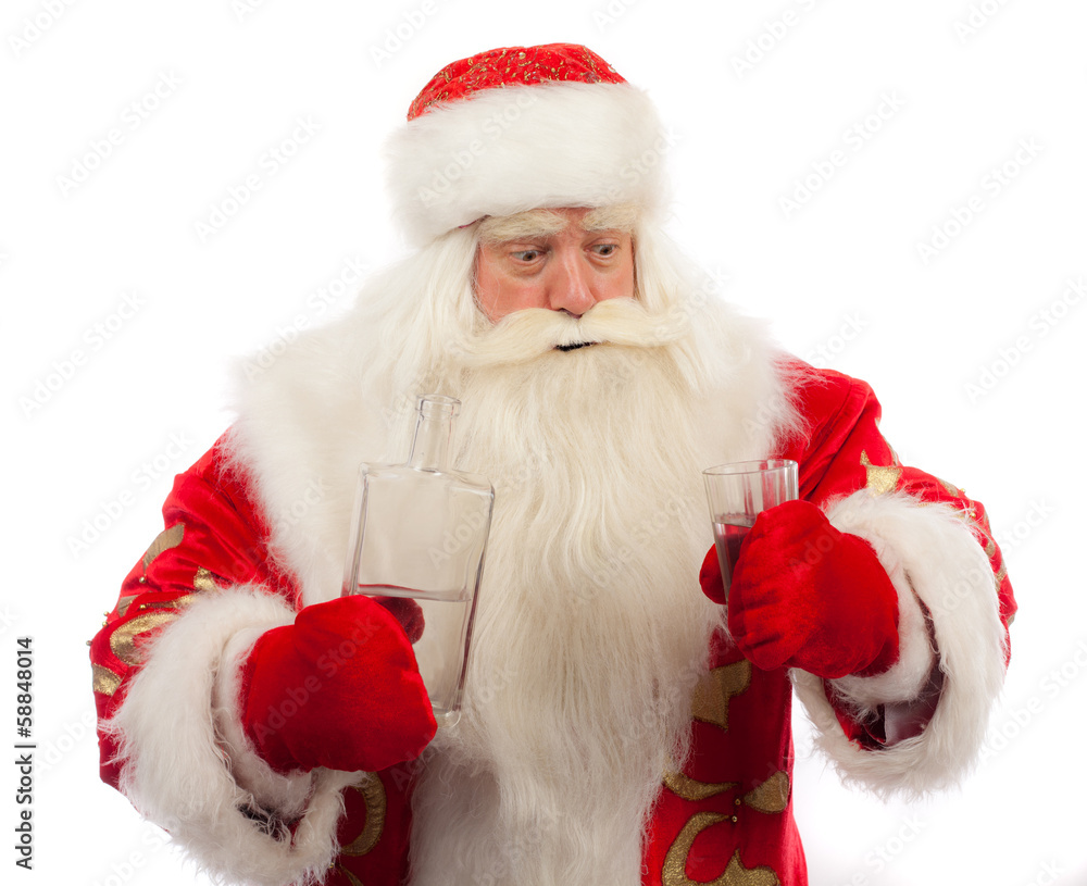 Santa Claus is pouring vodka into the glass. Stock-Foto | Adobe Stock