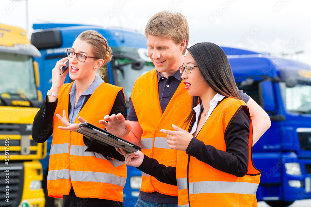 Forwarder in front of trucks on a depot Stock Photo | Adobe Stock